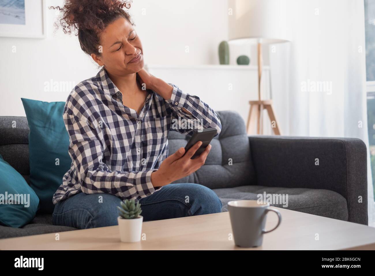 One black woman suffering having poor posture using mobile phone Stock ...