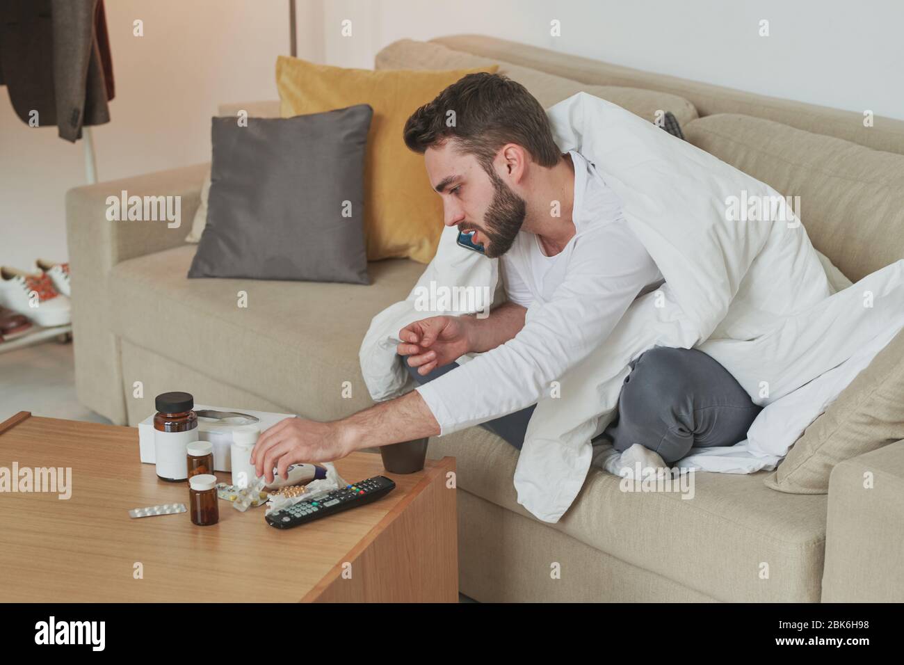 Young man bending over table hi-res stock photography and images - Alamy