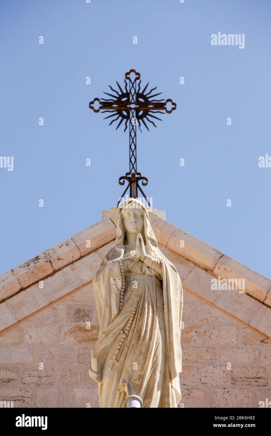 Statue maria with cross and blue sky Stock Photo - Alamy
