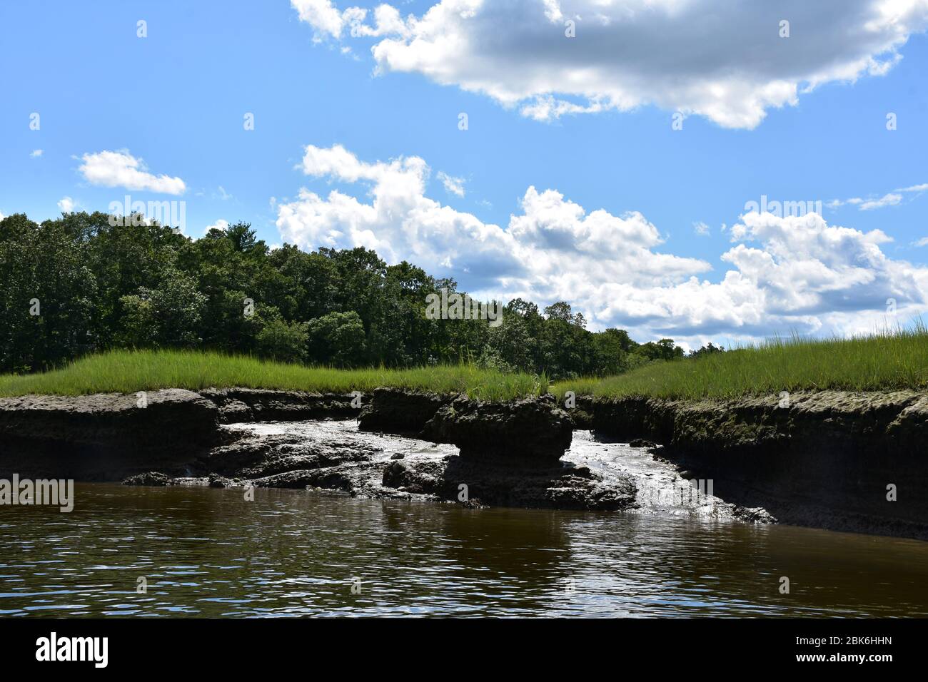 Pretty marsh land and tidal flats under cloudy skies Stock Photo - Alamy
