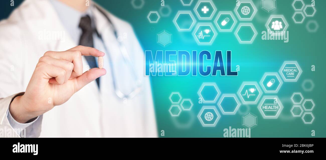 Close-up of a doctor giving you a pill with MEDICAL inscription ...