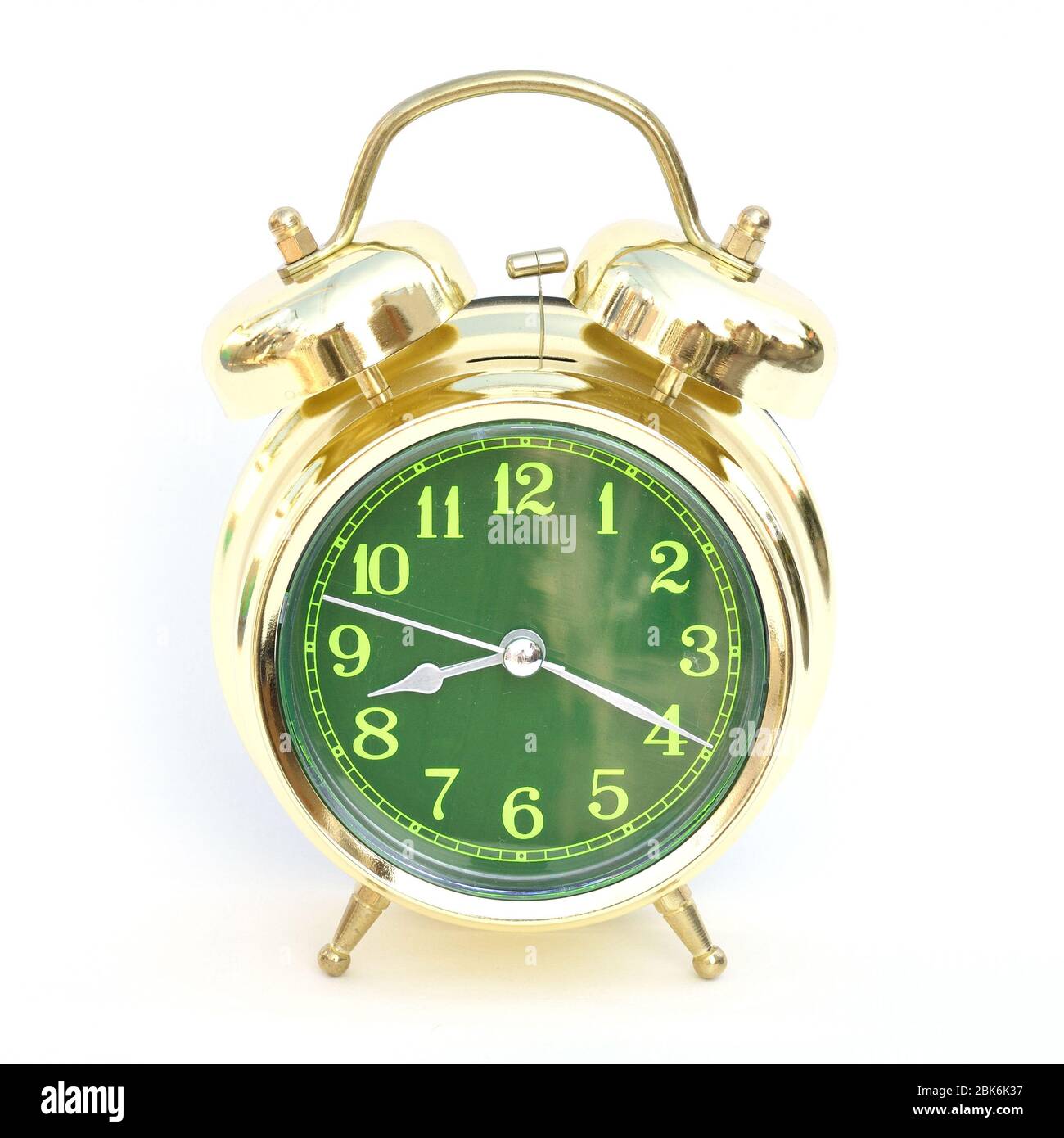 Gold old style alarm clock on white background Stock Photo - Alamy