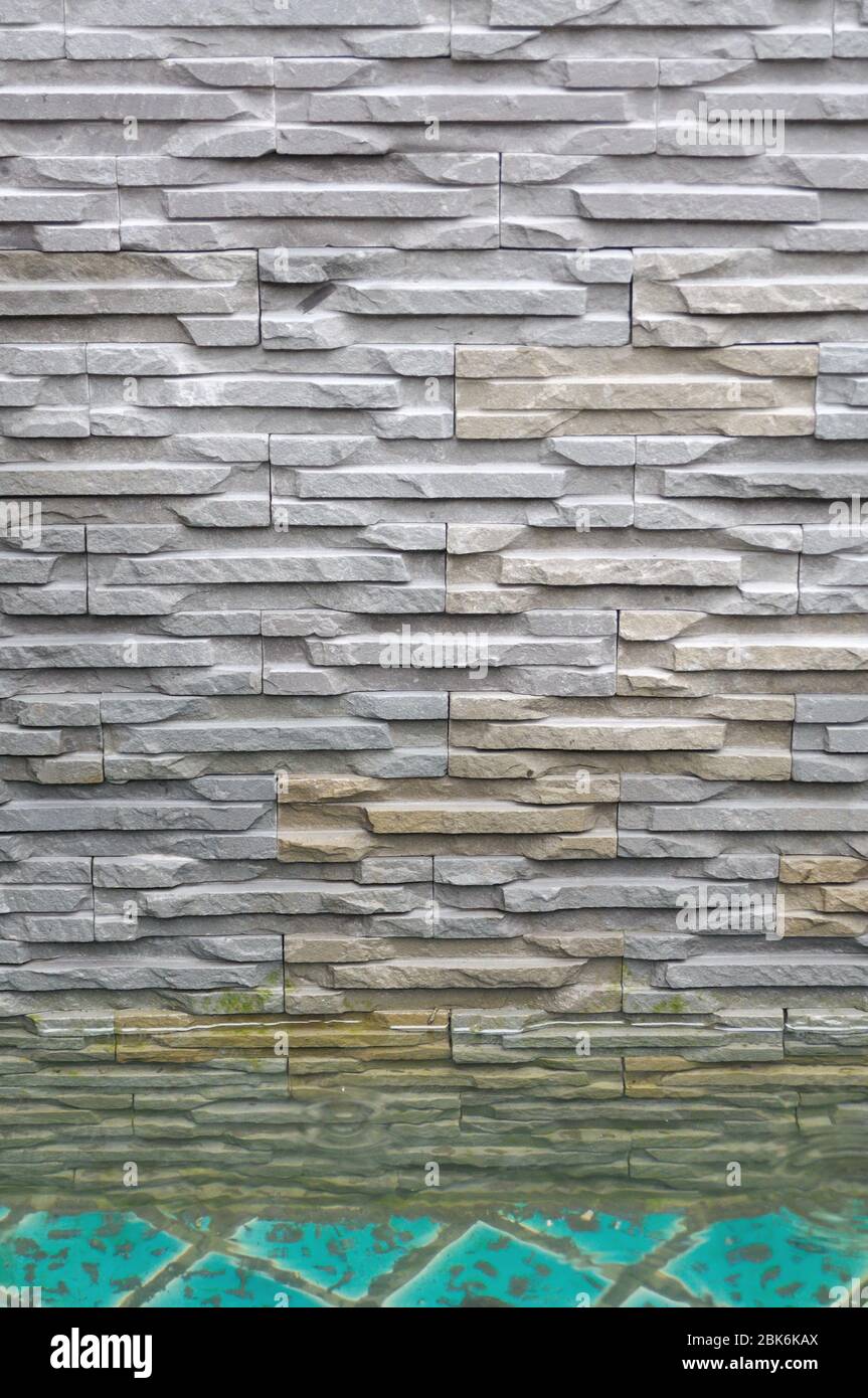 Stone wall in pool Stock Photo - Alamy