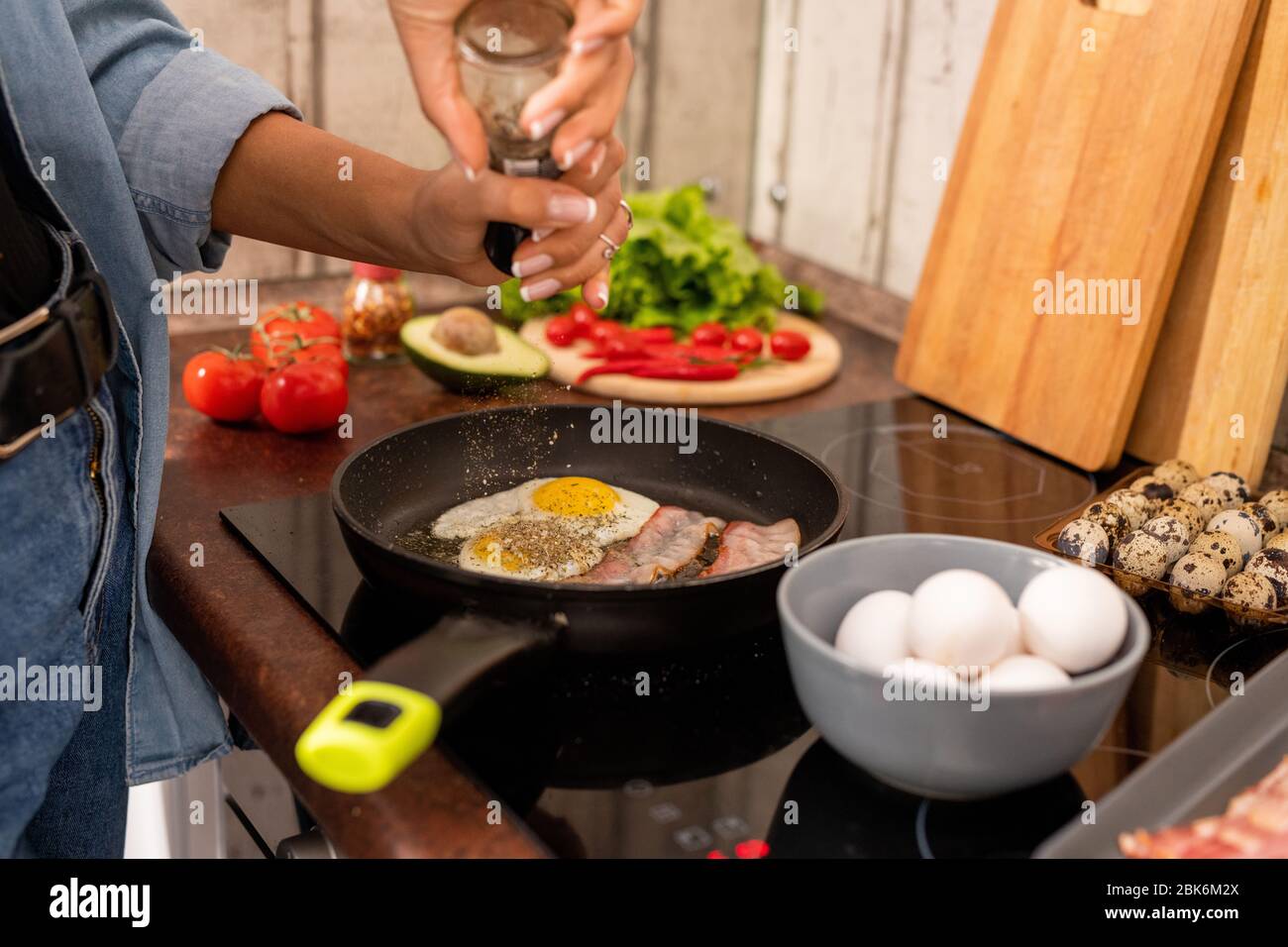 Woman frying bacon hi-res stock photography and images - Alamy