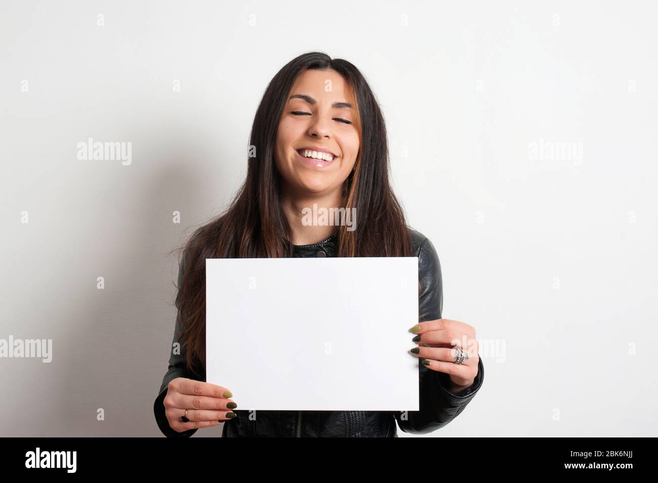 beautiful smiling brunette girl with placard, on white background Stock ...