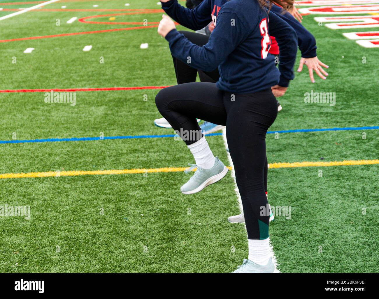 High school girls track and field team performing the speed drill A ...