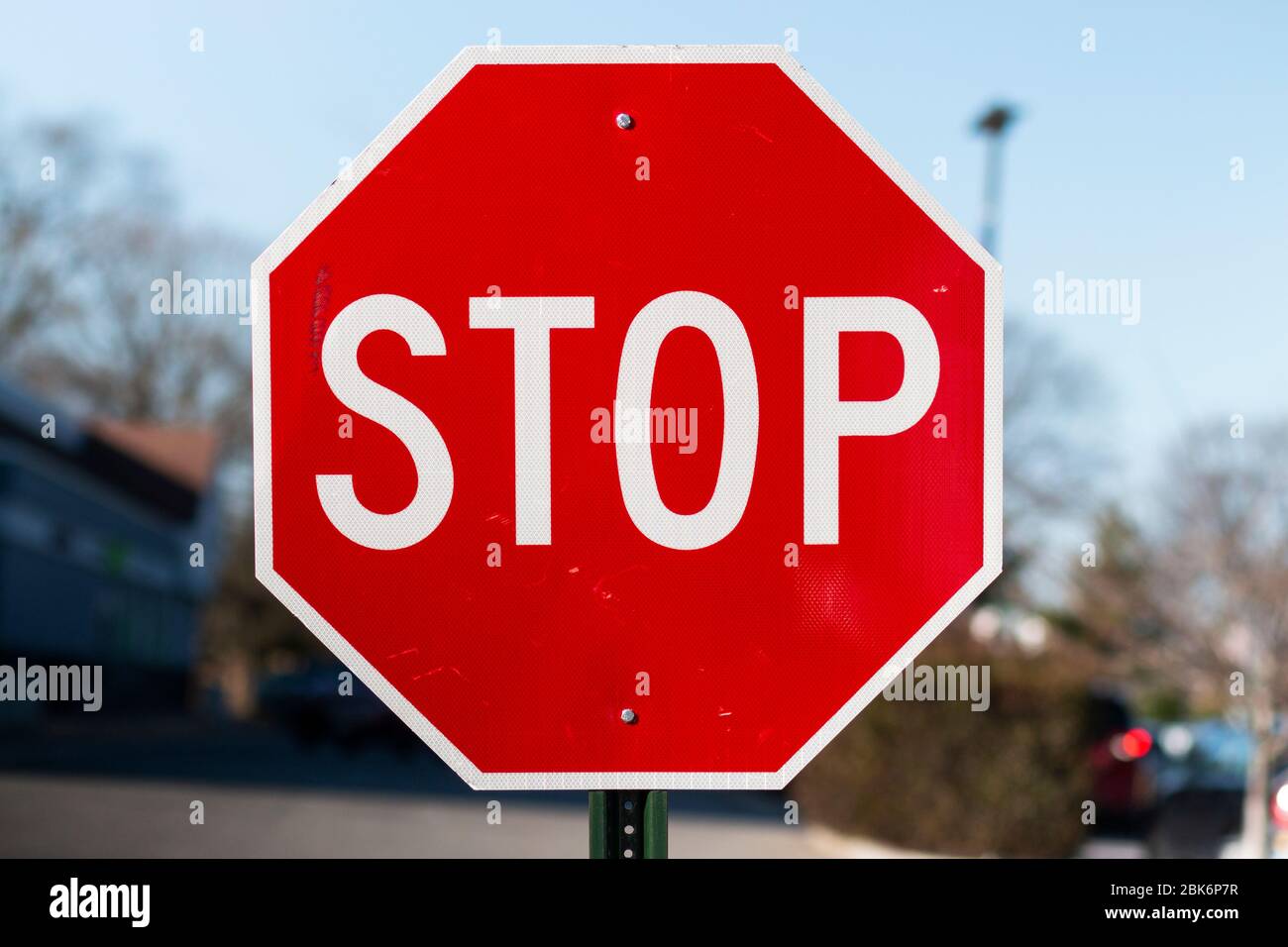 A close up of a red stop sign outside in a parking lot Stock Photo - Alamy