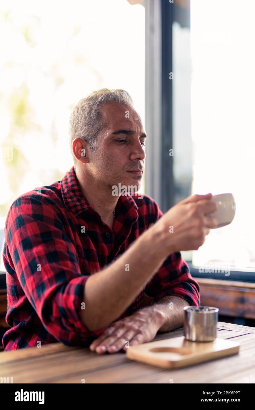 Handsome Persian man relaxing at the coffee shop Stock Photo - Alamy