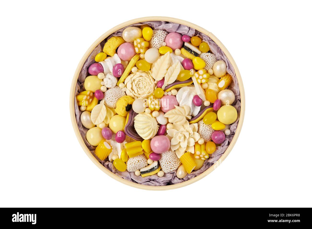 Yellow round box filled with handmade white chocolate candies isolated ...