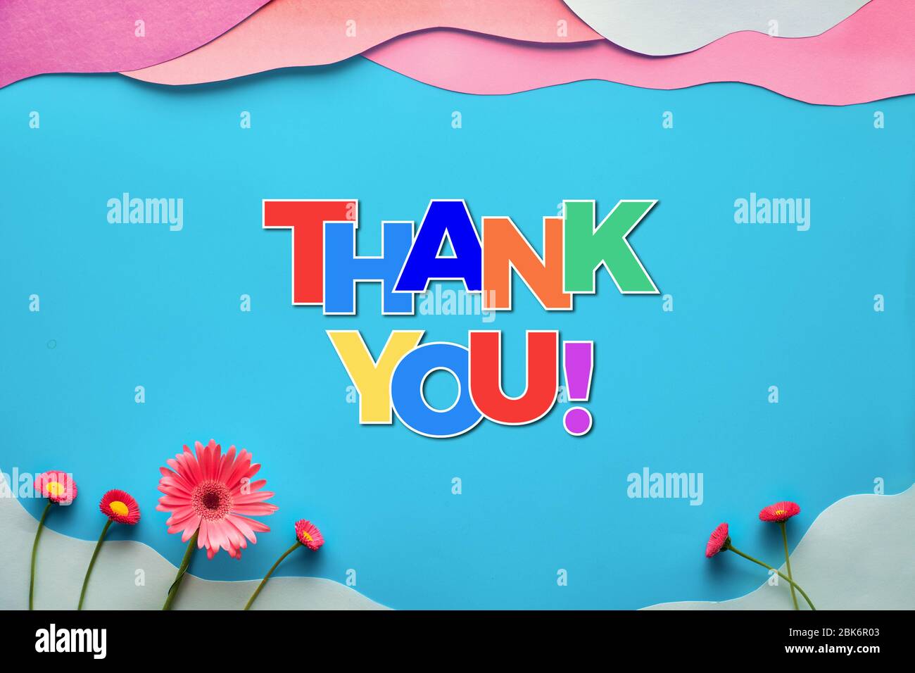 Thank you text in rainbow letters on layered colorful paper background ...