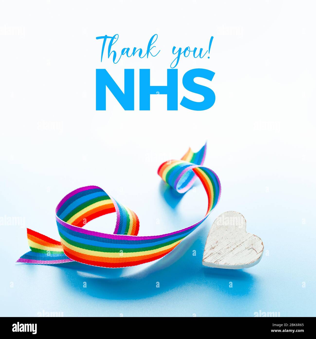 "Thank you NHS" on blue background. Rainbow ribbon and hand holding ...