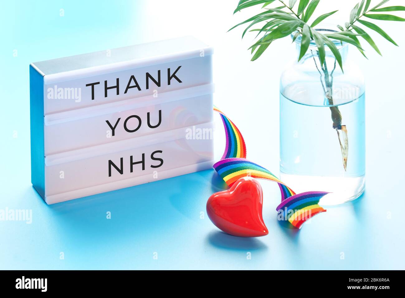 Lightbox with text "Thank you NHS", bottle with palm leaf. Heart ...
