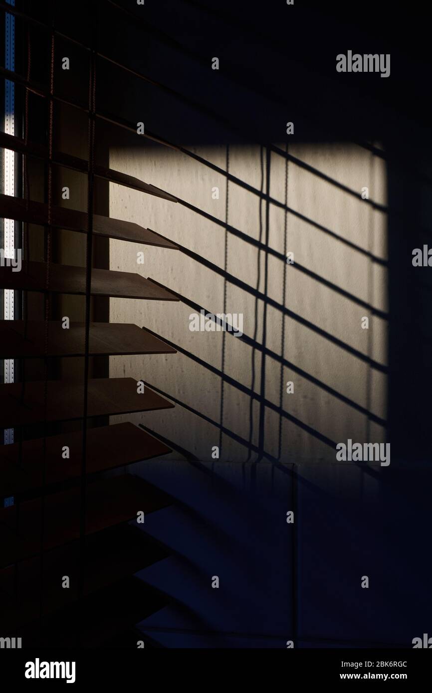Light falling through blinds on to interior wall Stock Photo - Alamy