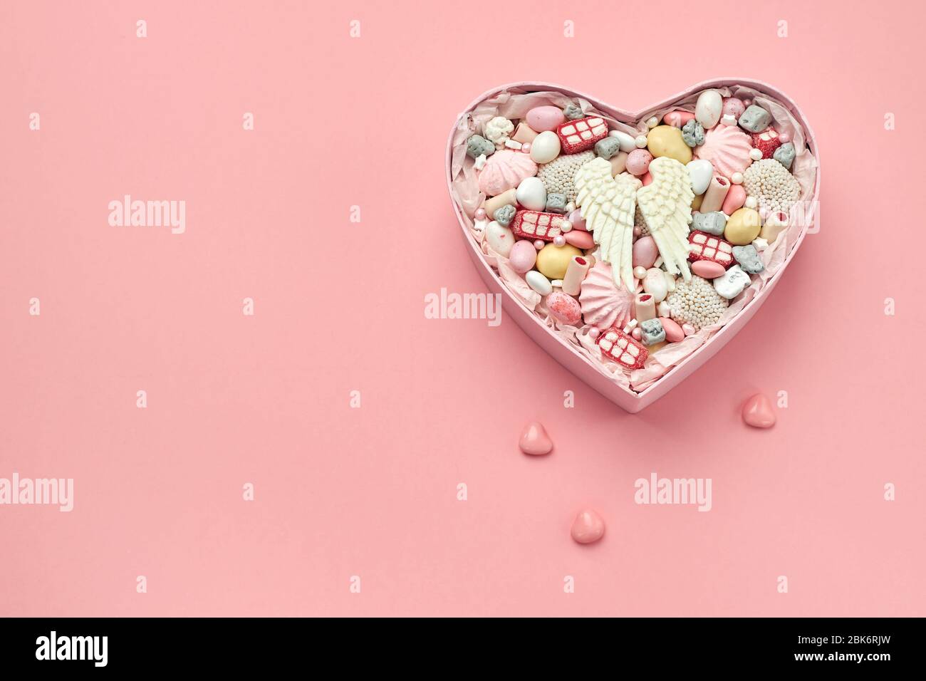 Heart shaped box filled with different sweets and handmade candies on a ...
