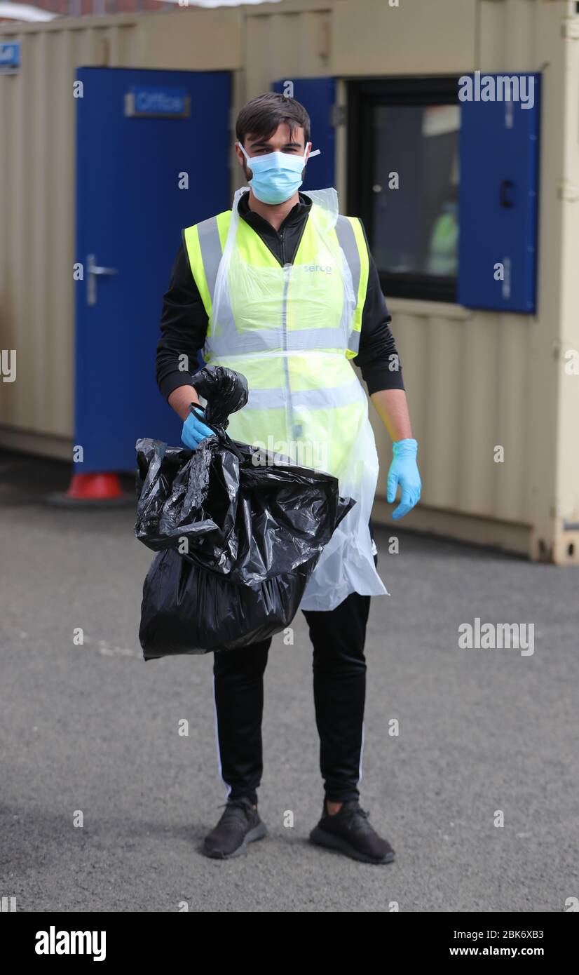 A member of the testing staff carries a sealed bag containing Randox ...