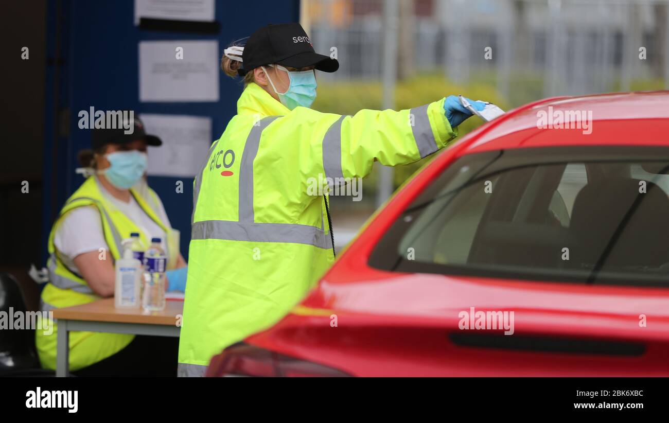 A member of staff hands over a Randox laboratories Covid-19 self test ...