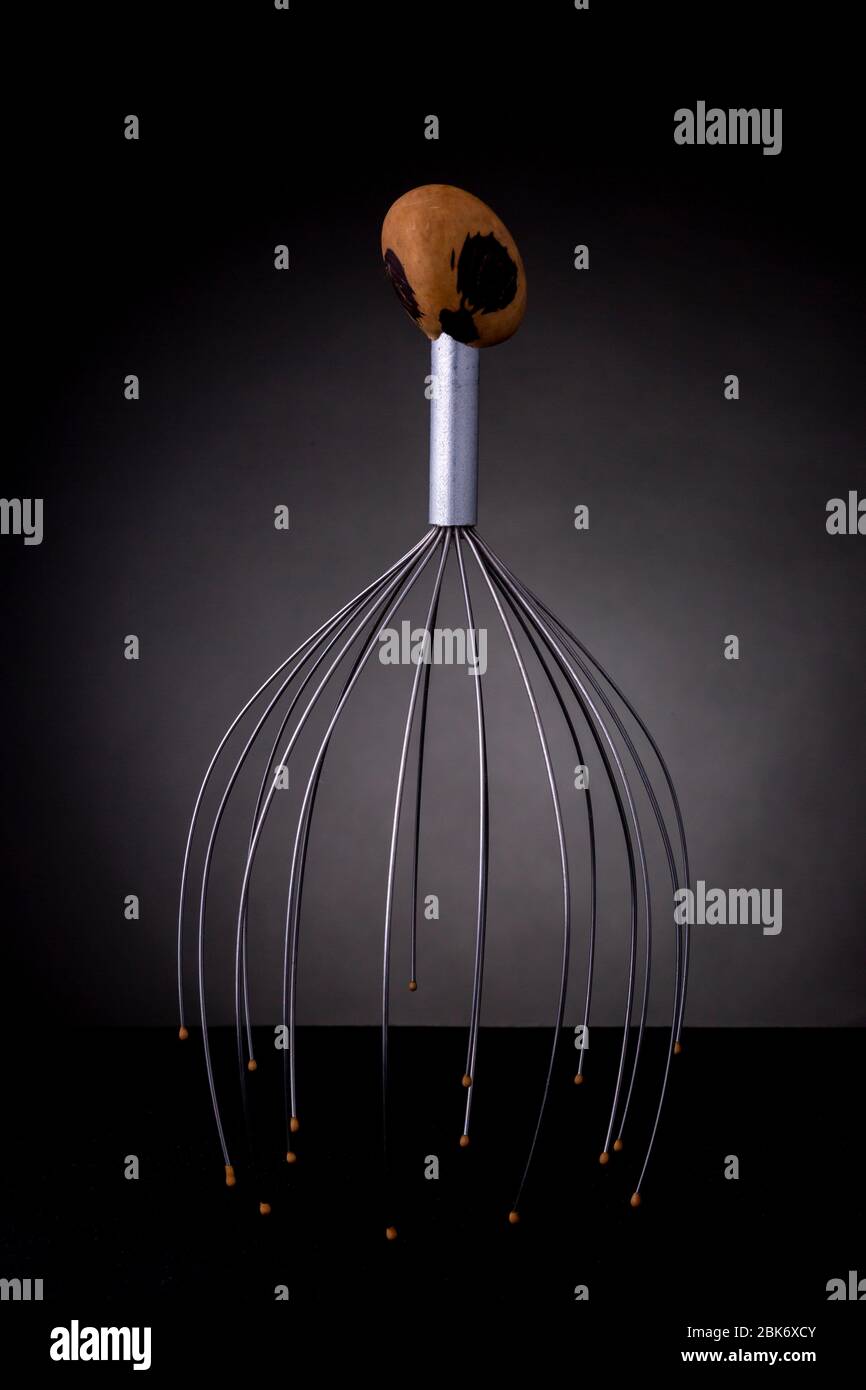 Upright standing head massage tool with rounded tips and wooden handle ...