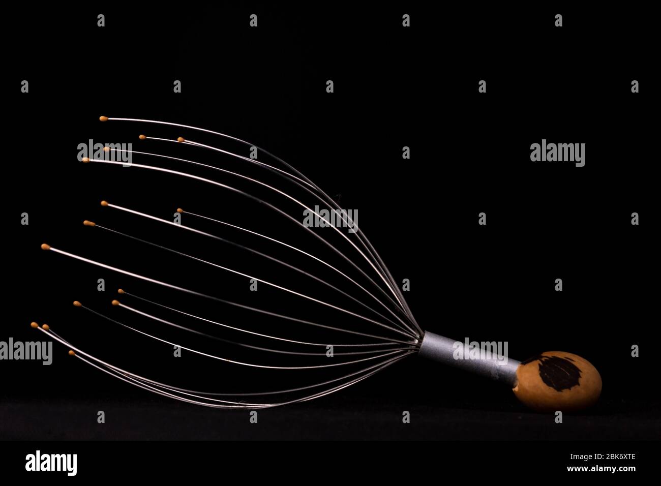 Head massage tool with rounded tips performing a type of acupressure on ...