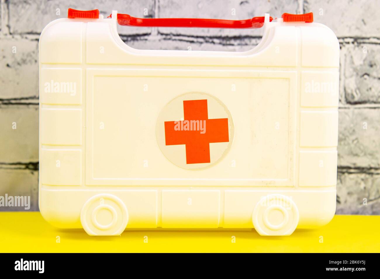 Toy - First aid kit on yellow table. Set of little doctor. Close-up ...