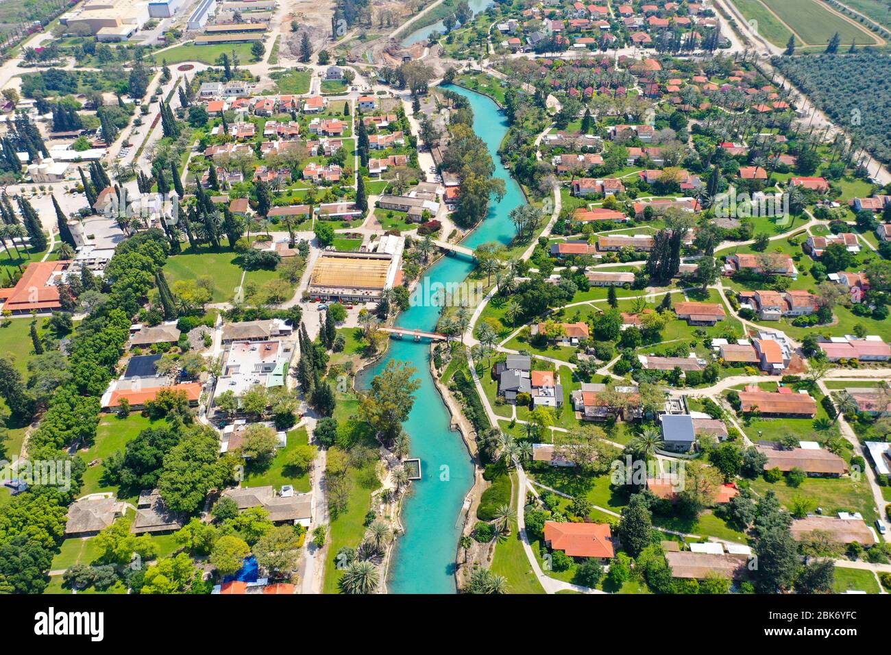 Aerial image of Kibbutz Nir David with Amal river channel turquoise ...