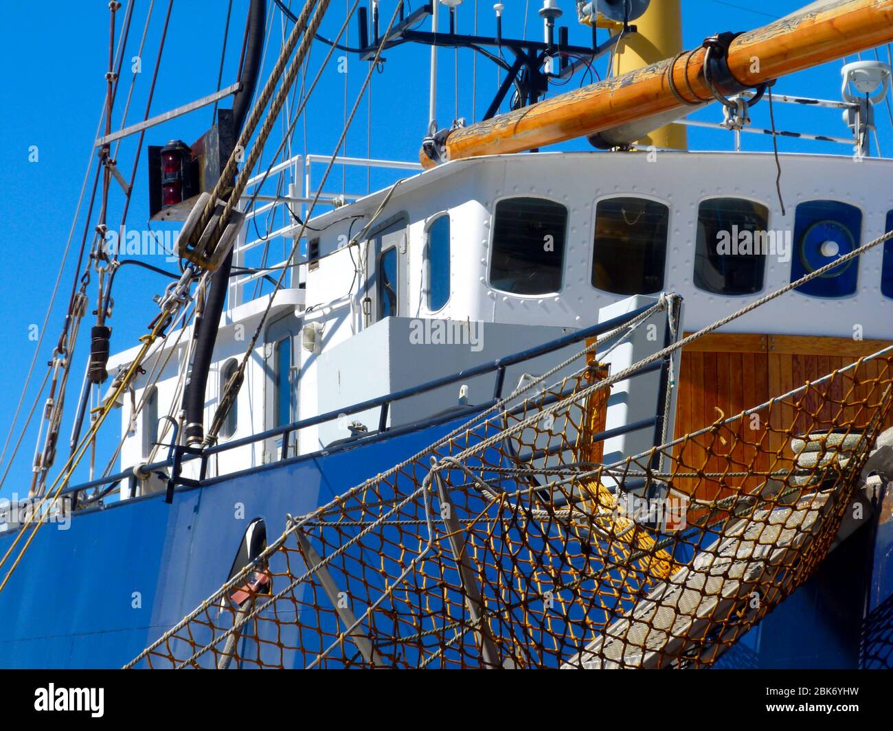 vintage sailboat detail. yellow stained wooden mast & cross beam in ...