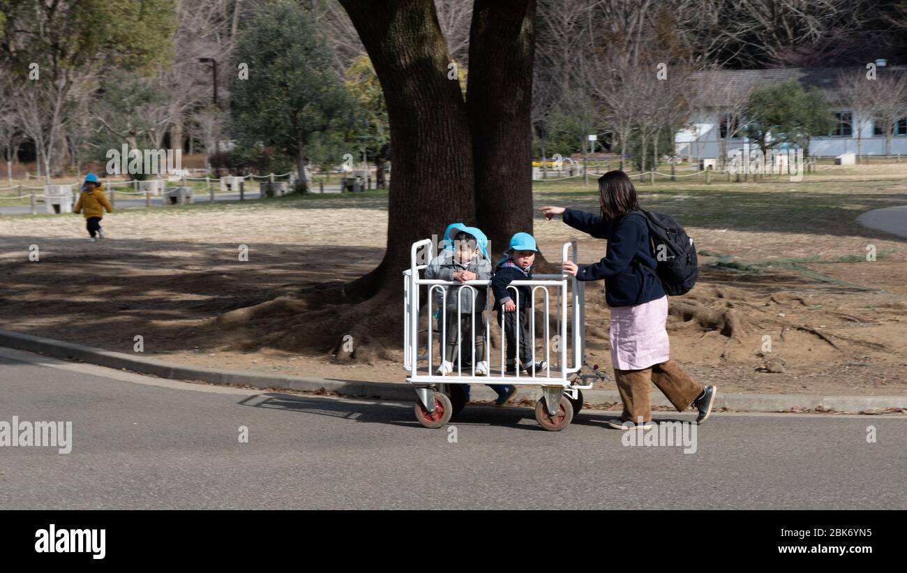 Child Minder Pushing Children in a Cart, Tokyo, Japan Stock Photo - Alamy