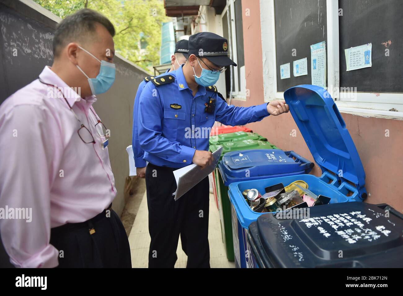 Beijing, China. 2nd May, 2020. Urban management workers inspect garbage ...