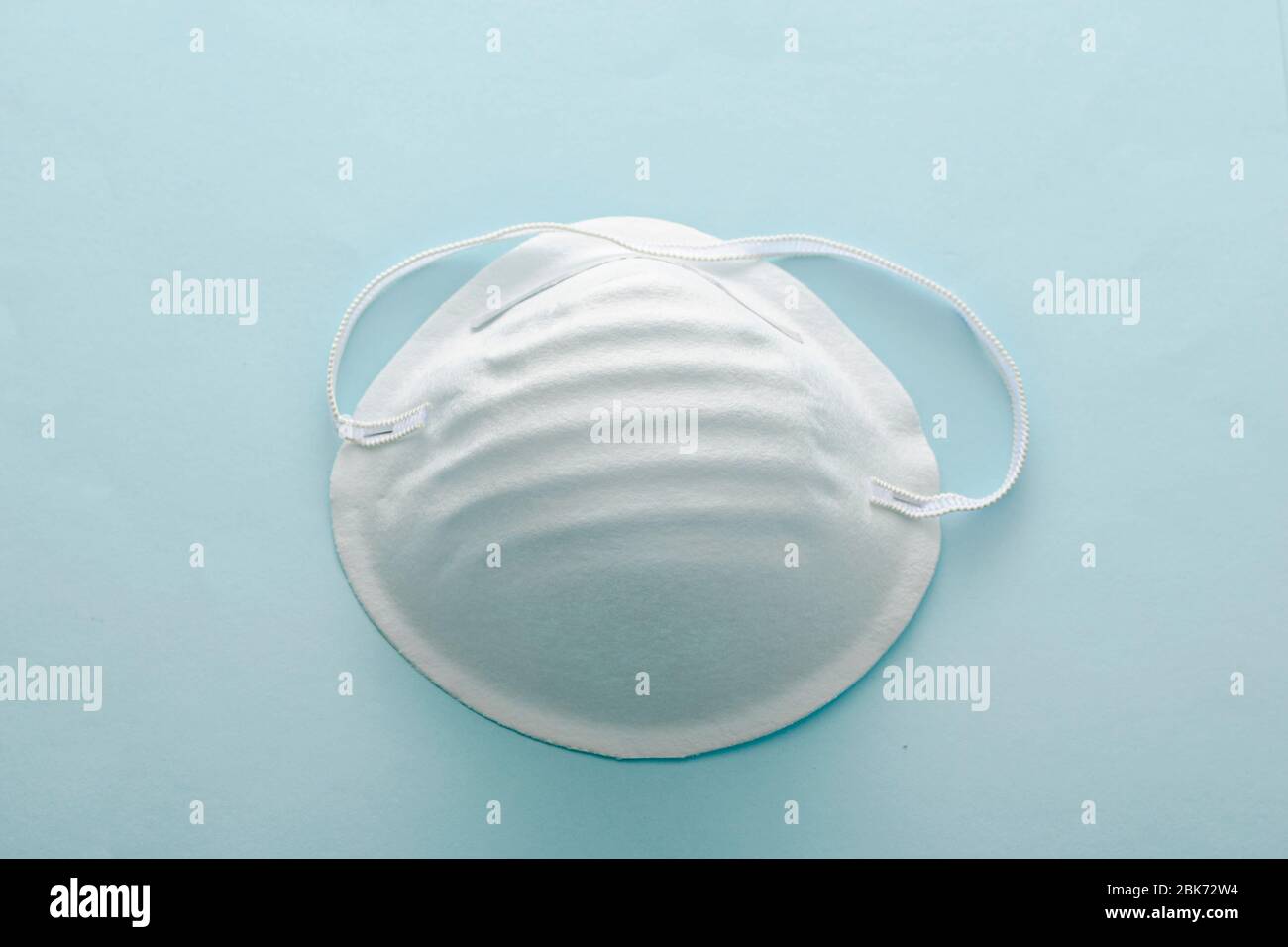 Single surgical face mask on a grey background for use as protection ...