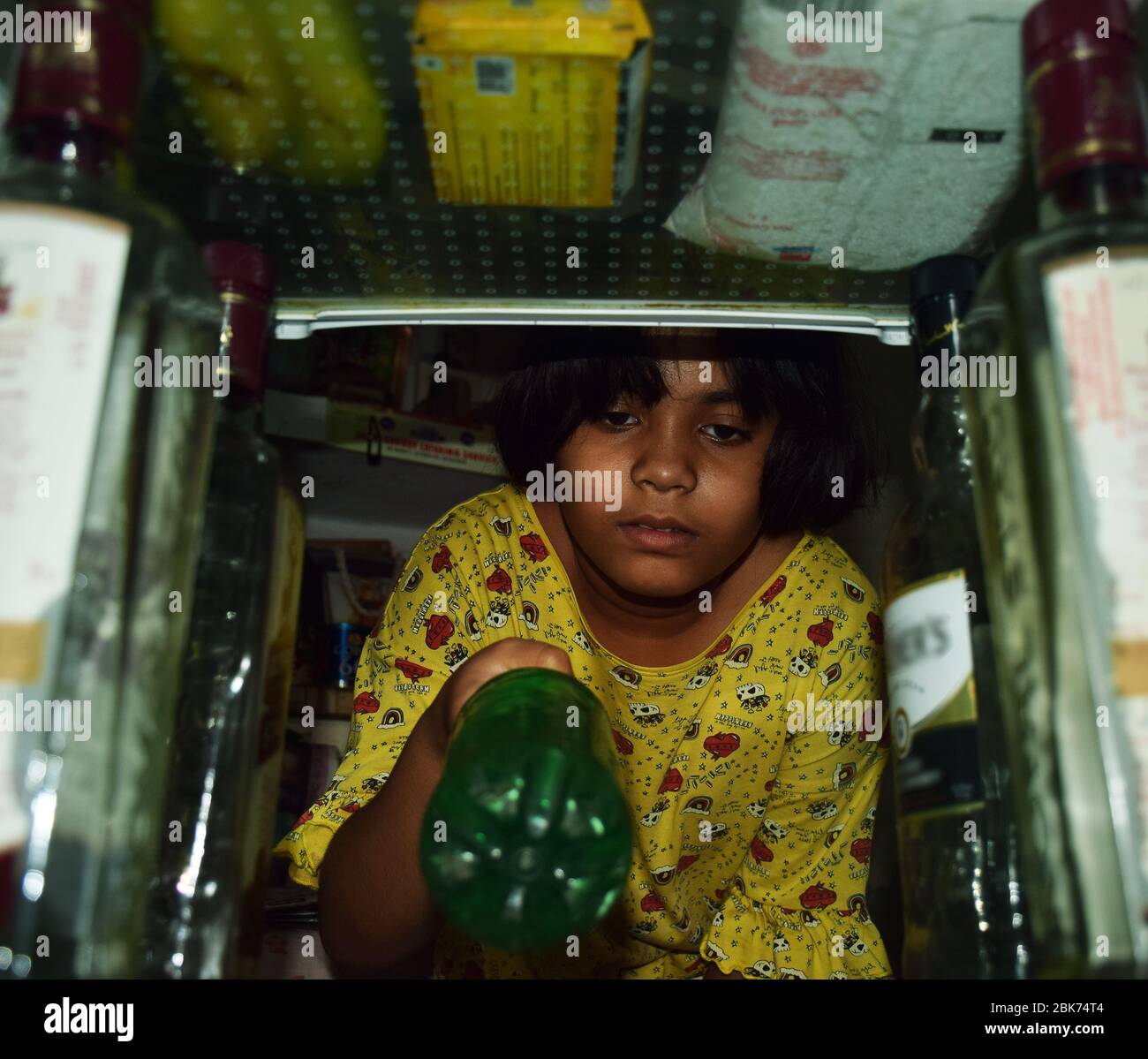 Indian girl taking out water from fridge or refrigerator Stock Photo ...