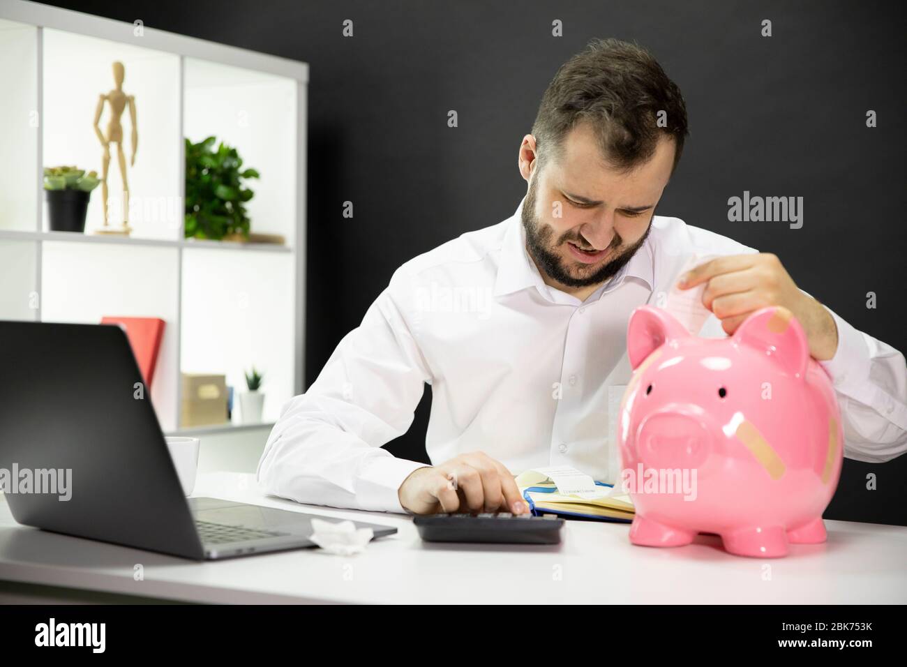 Crying businessman calculate bills worried about bankruptcy, broken ...