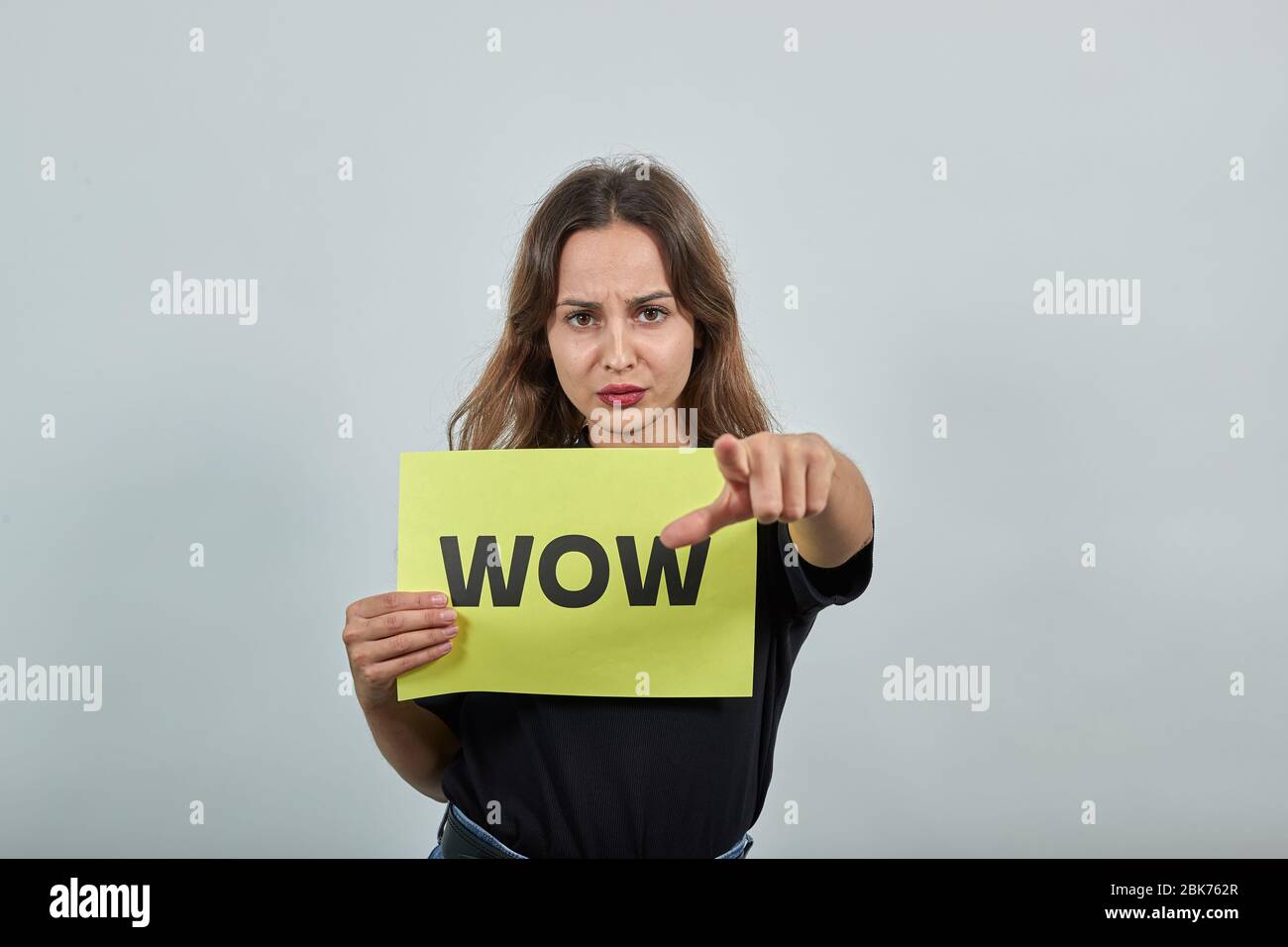 Irritated Girl Points Fault, Pointing Index Finger, Holding Yellow ...