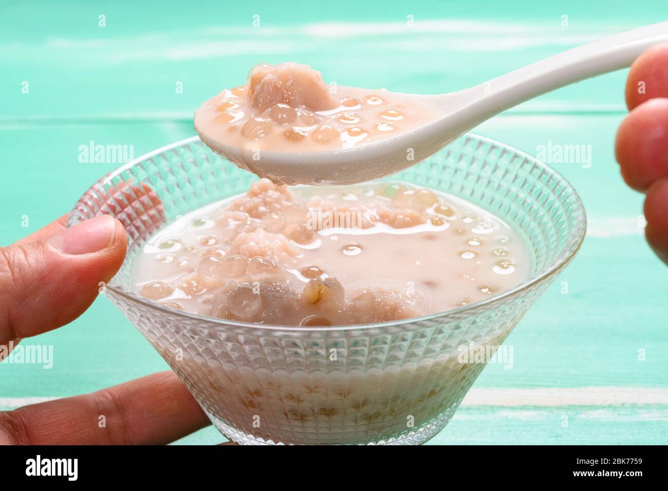 man eating Chinese syrup of sweet potato and sago Stock Photo - Alamy