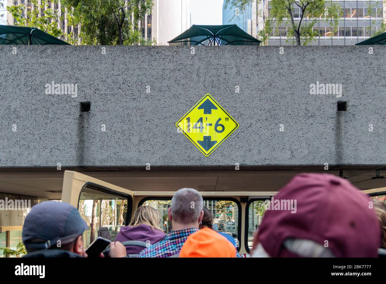 Tourist bus passes under low bridge Stock Photo - Alamy