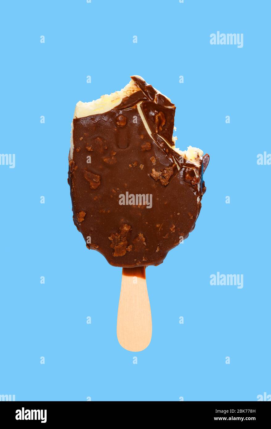 chocolate outer popsicle with some bite on blue background Stock Photo ...