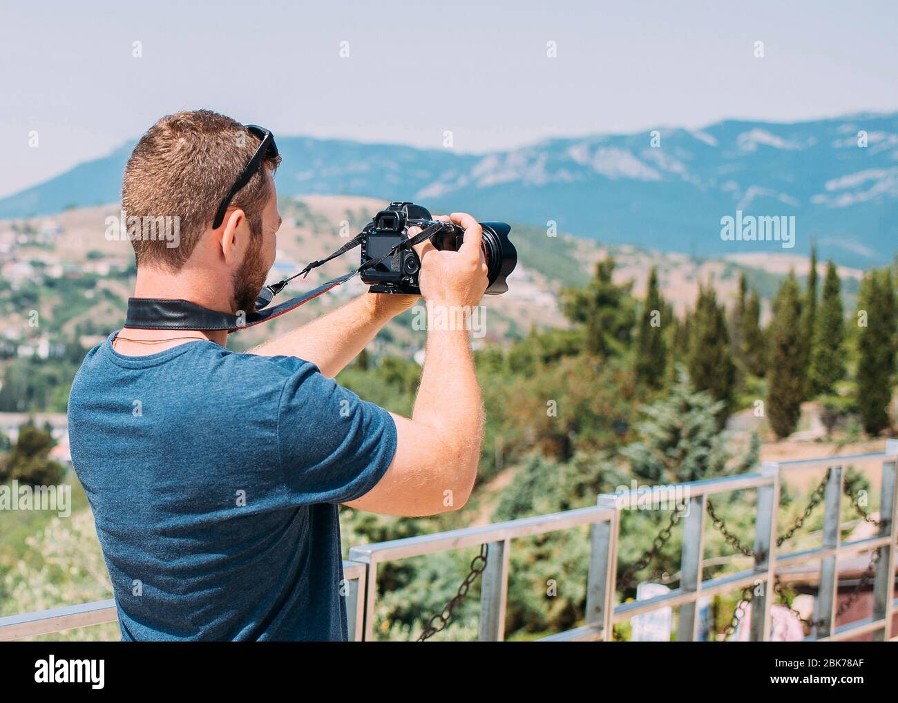 Man holding camera in his hands and making photos of the mountains ...