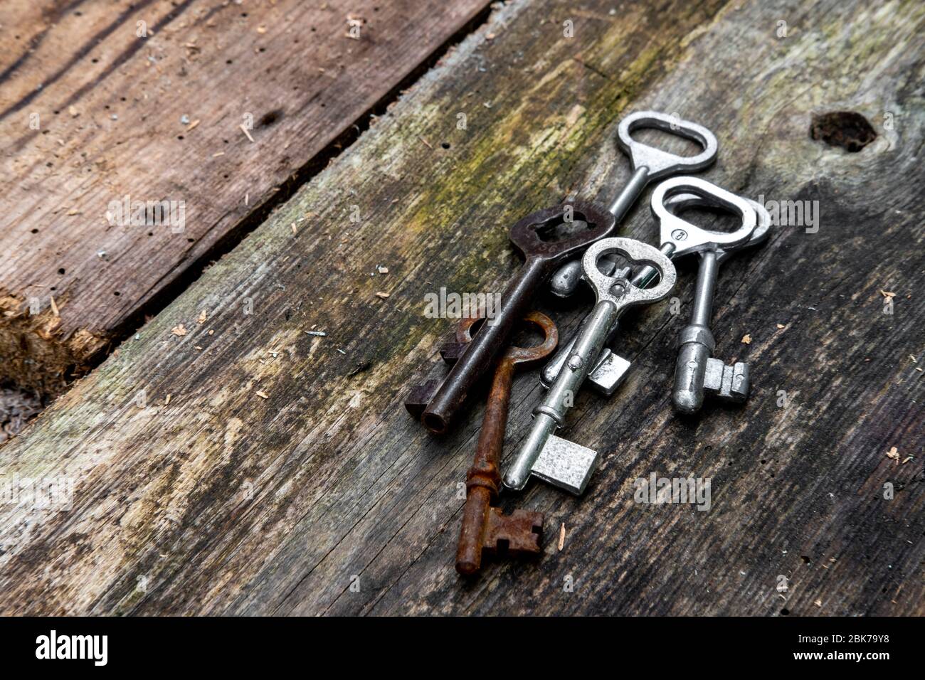 Old keys of different sizes on rustic weathered wood planks Stock Photo ...