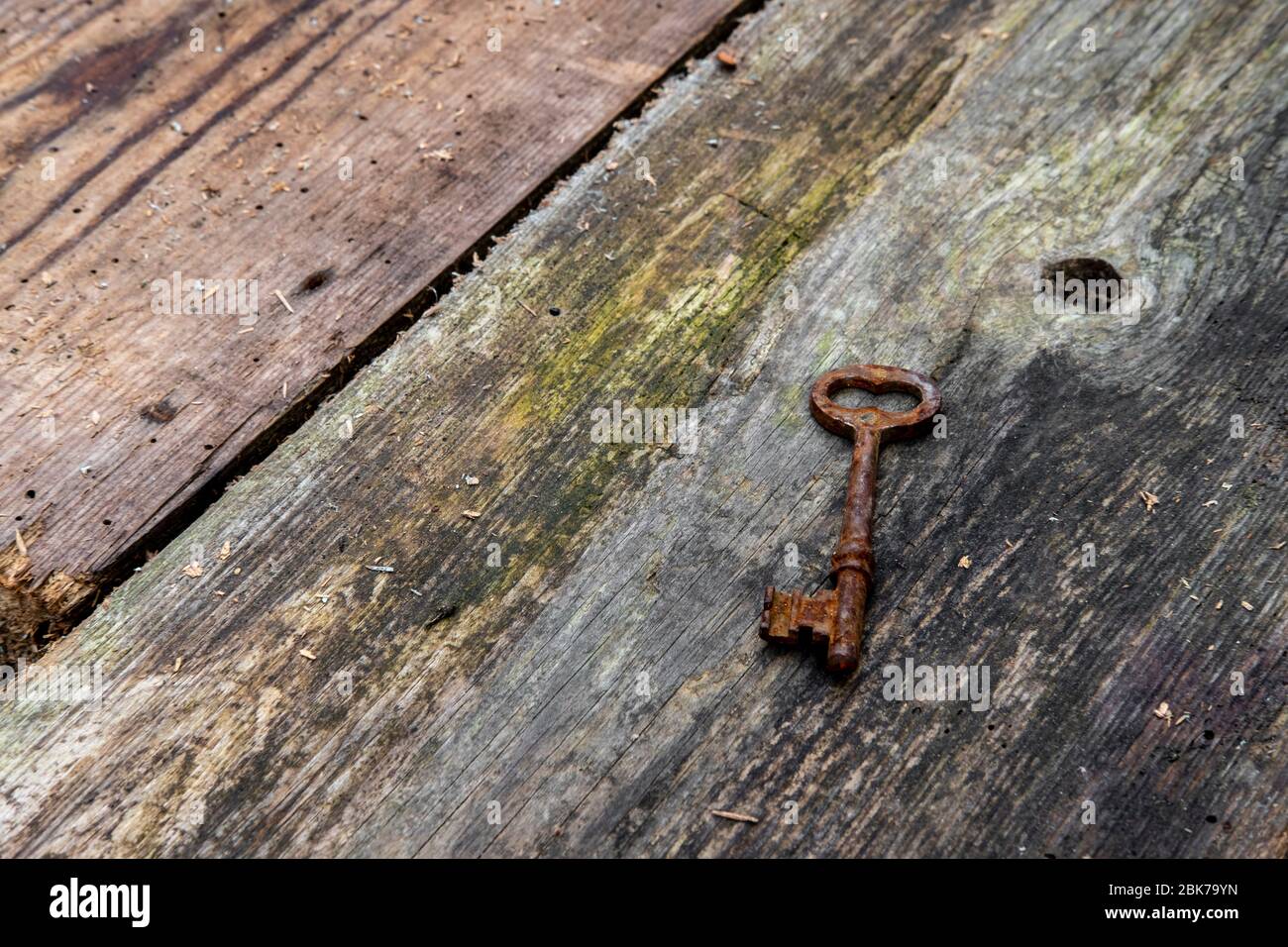 key on a rustic wooden background Stock Photo - Alamy