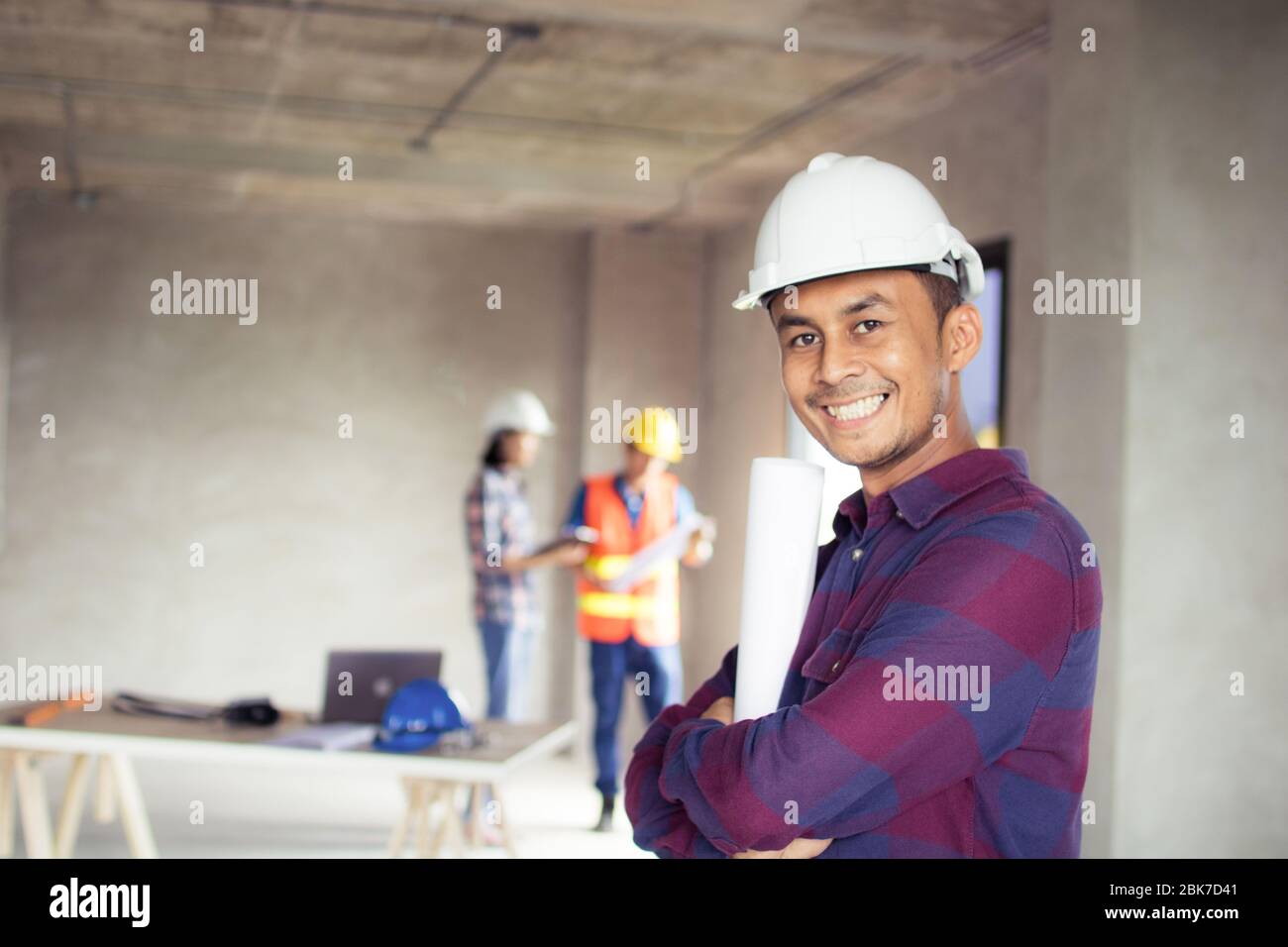 portrait engineer holding blueprint in construction site with architect ...
