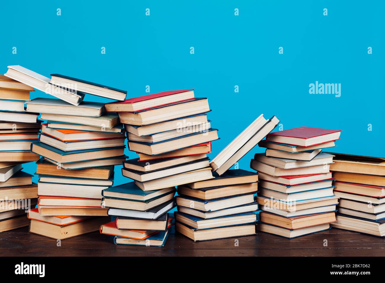 many stacks of educational books for exams at school in the library on ...