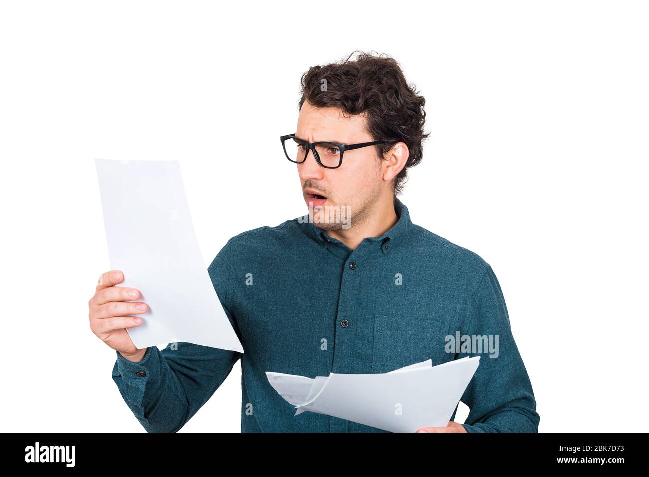 Perplexed businessman looking stunned at paper documents isolated on ...