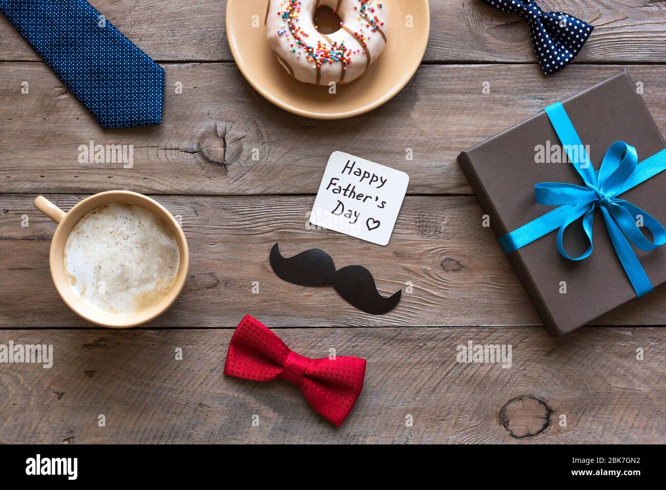 Happy Fathers Day flat lay on wooden table. Morning coffee, donut, gift ...