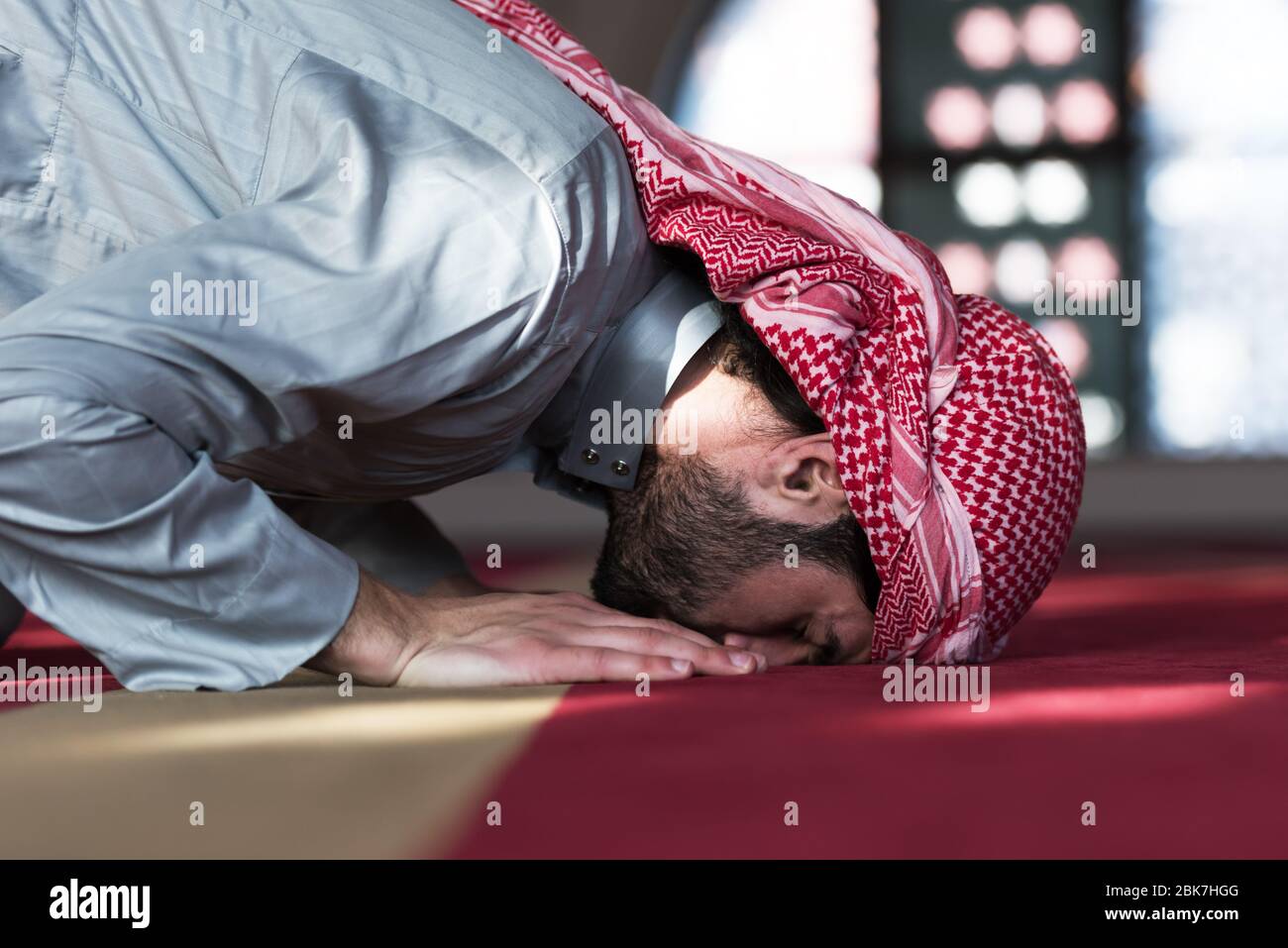 Young Arabic Muslim man praying. Doing a dailly pray inside modern ...