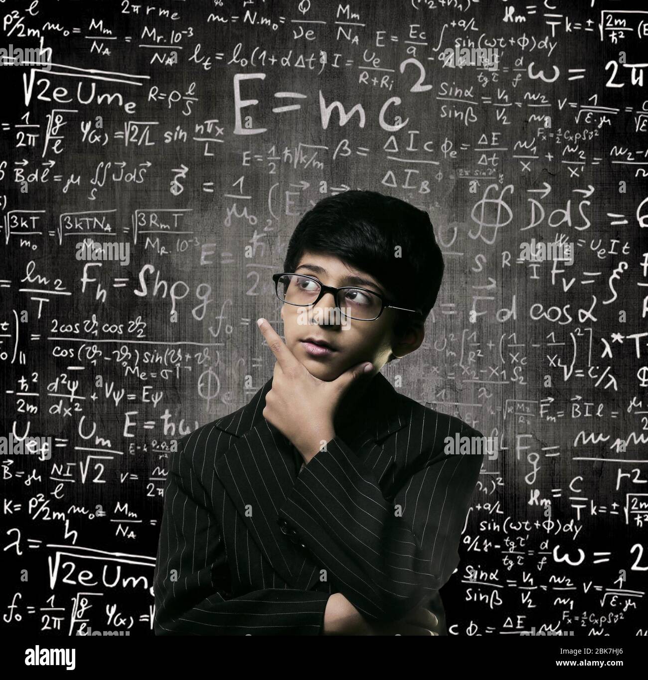 Cute Intelligent Little Boy Looking Up Thinking andWearing Glasses ...