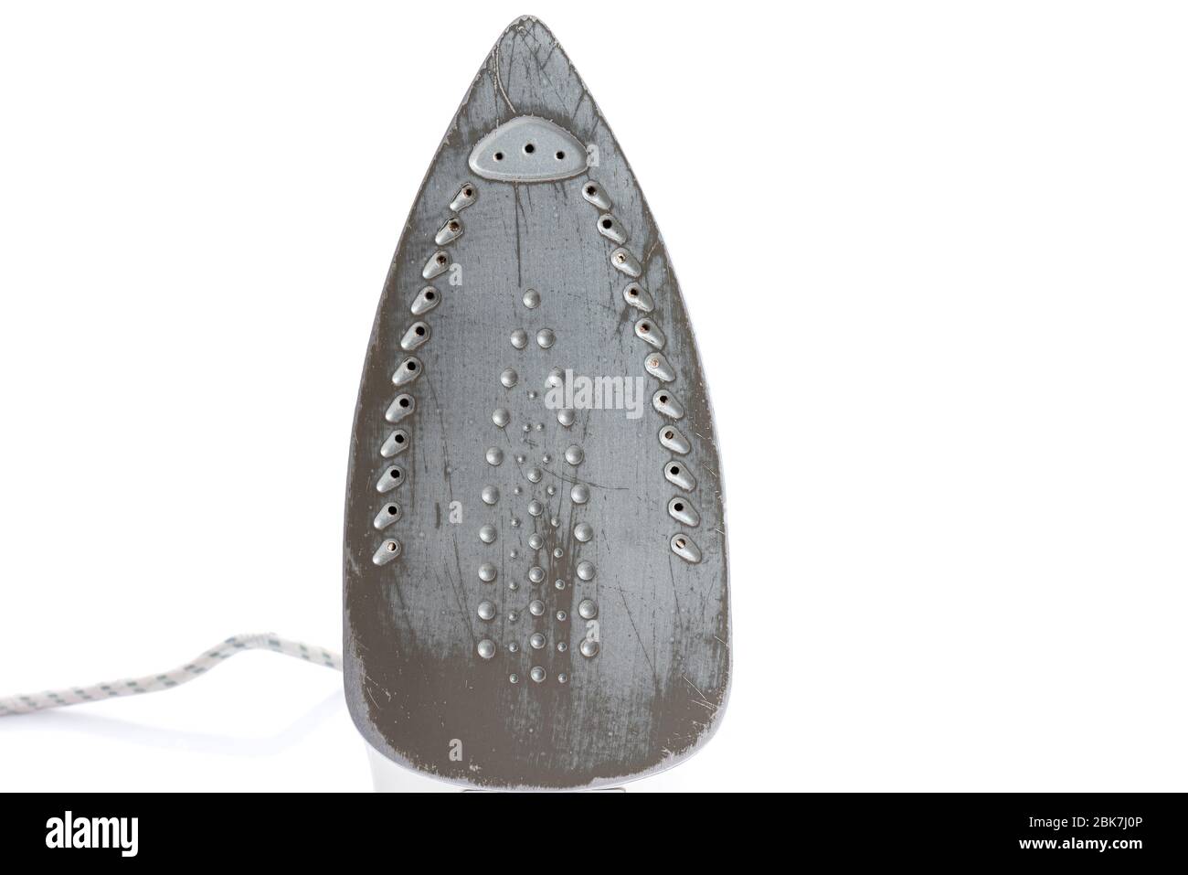Close up of used ironing tool on white background Stock Photo - Alamy