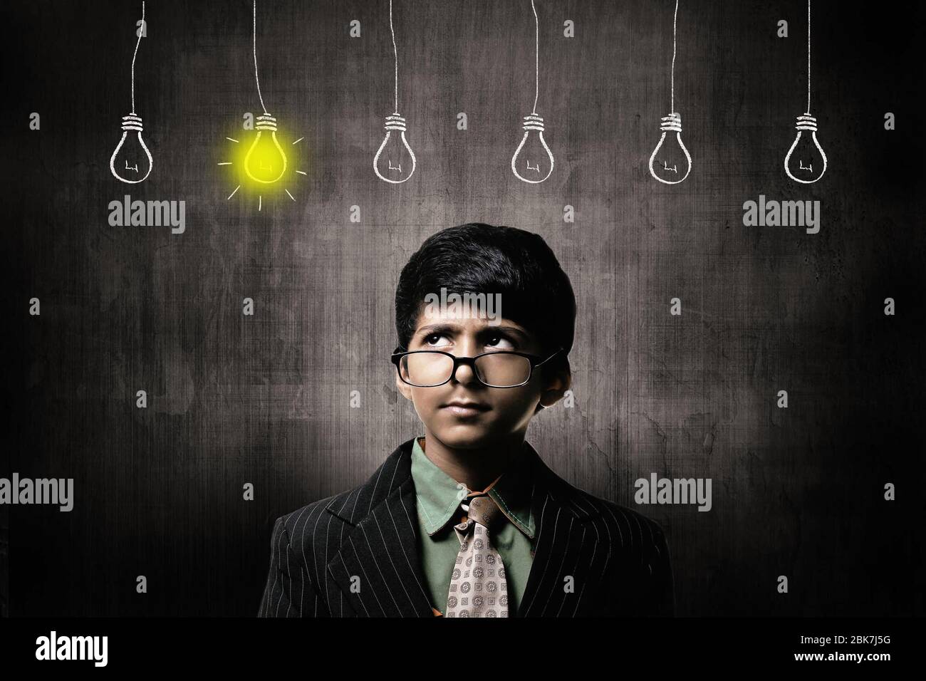 Cute Intelligent Little Boy Wearing Glasses On Nose, Thinking While ...