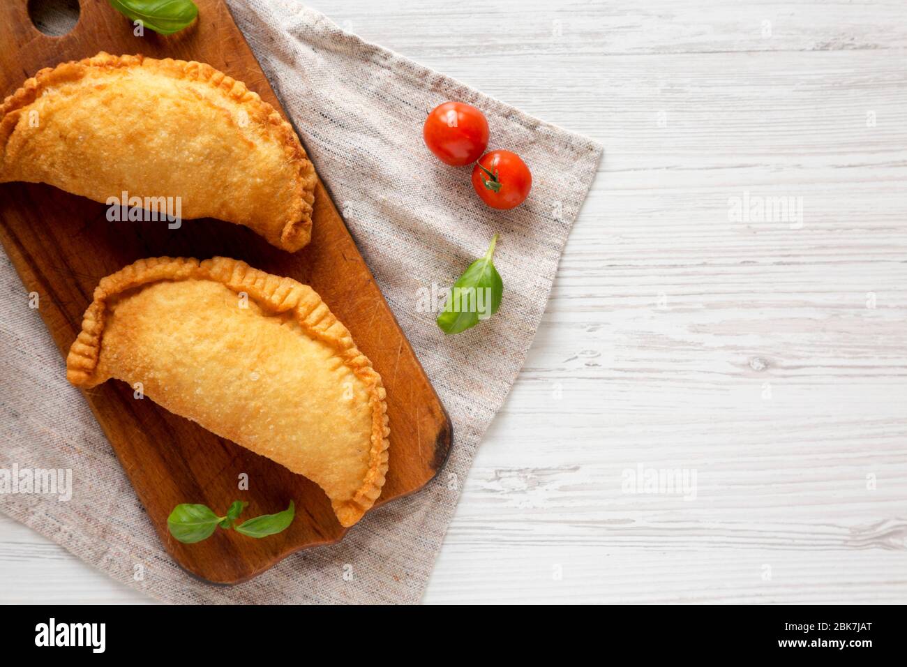 Homemade Deep Fried Italian Panzerotti Calzone on a rustic wooden board ...