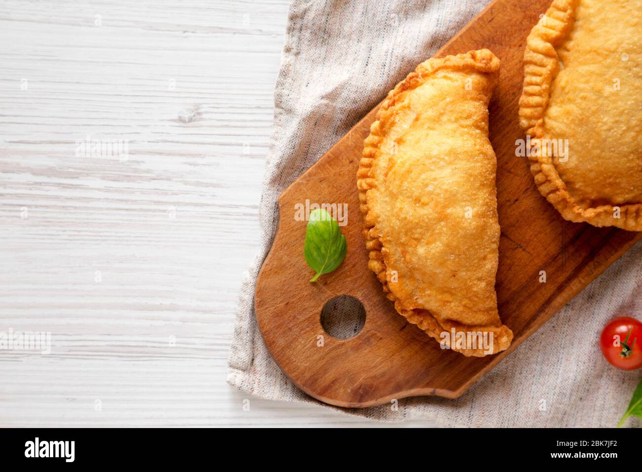 Homemade Deep Fried Italian Panzerotti Calzone on a rustic wooden board ...