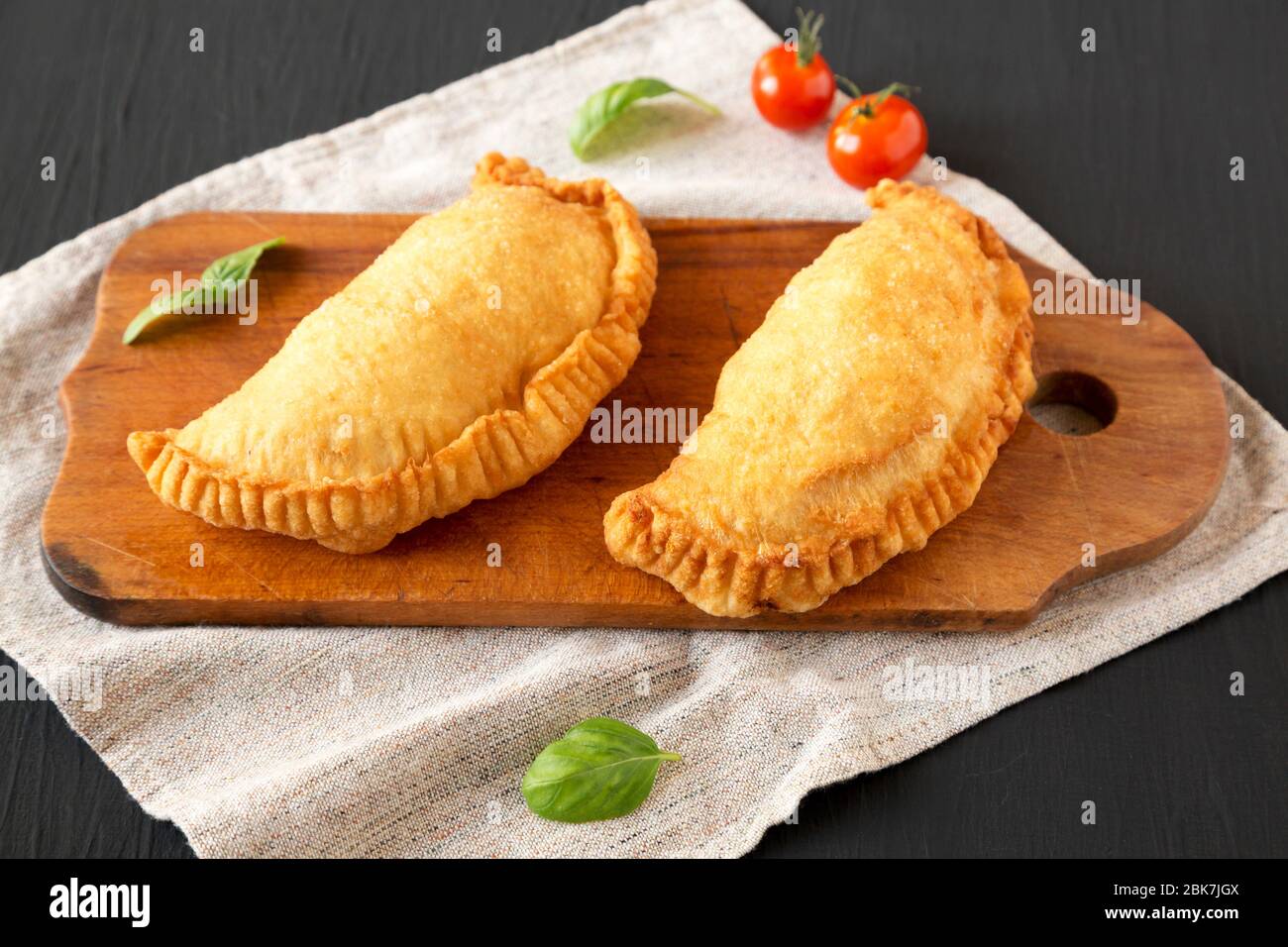 Homemade Deep Fried Italian Panzerotti Calzone on a rustic wooden board ...