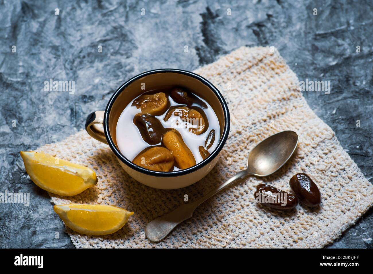 Homemade compote with dried fruit mix of dates and figs with lemon in a ...