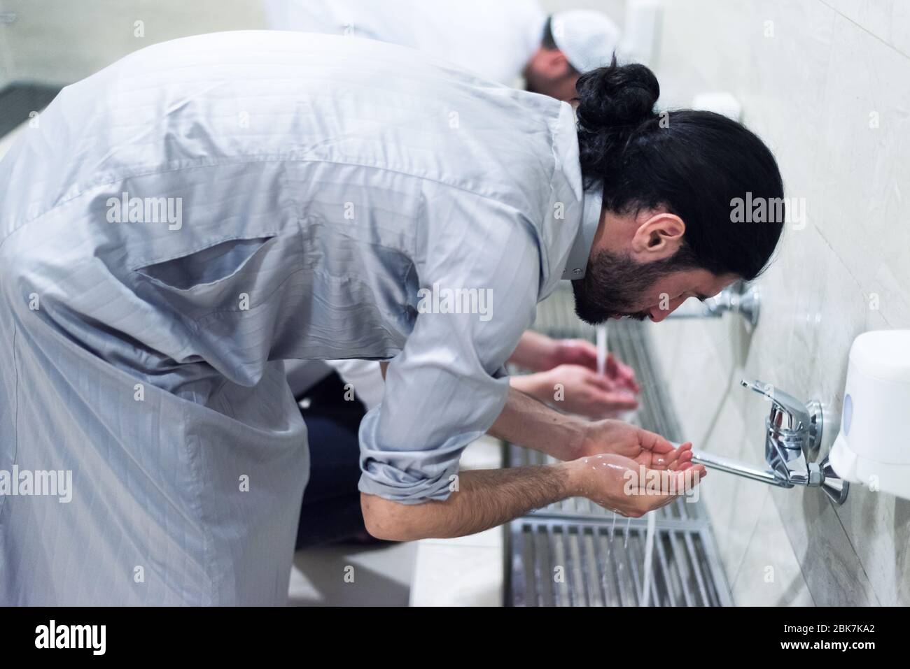 Two young Muslim people taking ablution for prayer. Islamic Religious ...